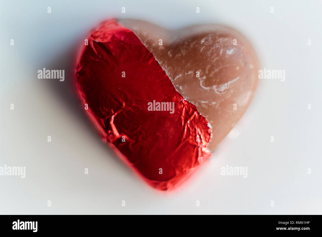 Chocolate Heart with wrapping half open Stock Photo - Alamy
