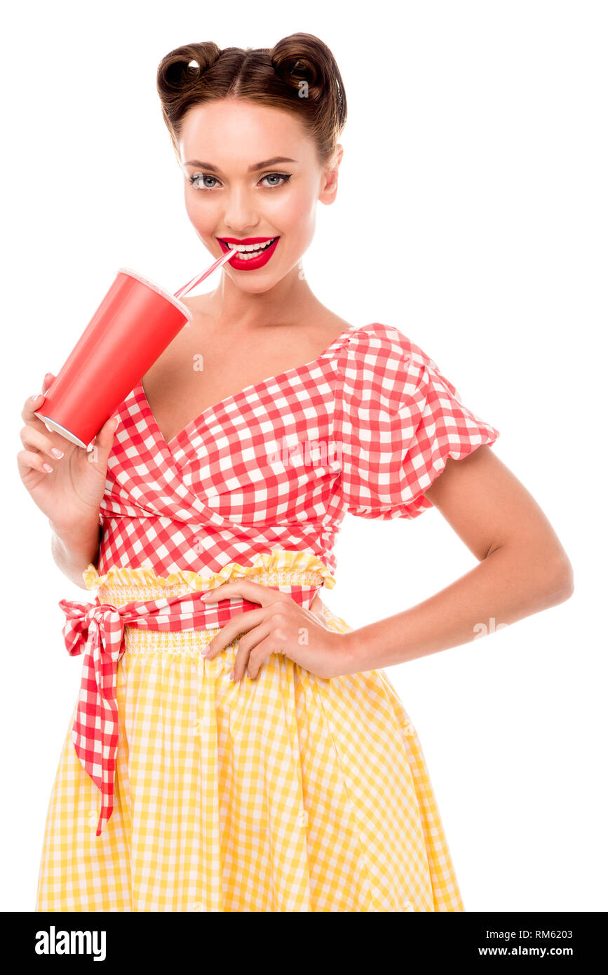 Smiling pin up girl drinking from paper cup with straw isolated on ...