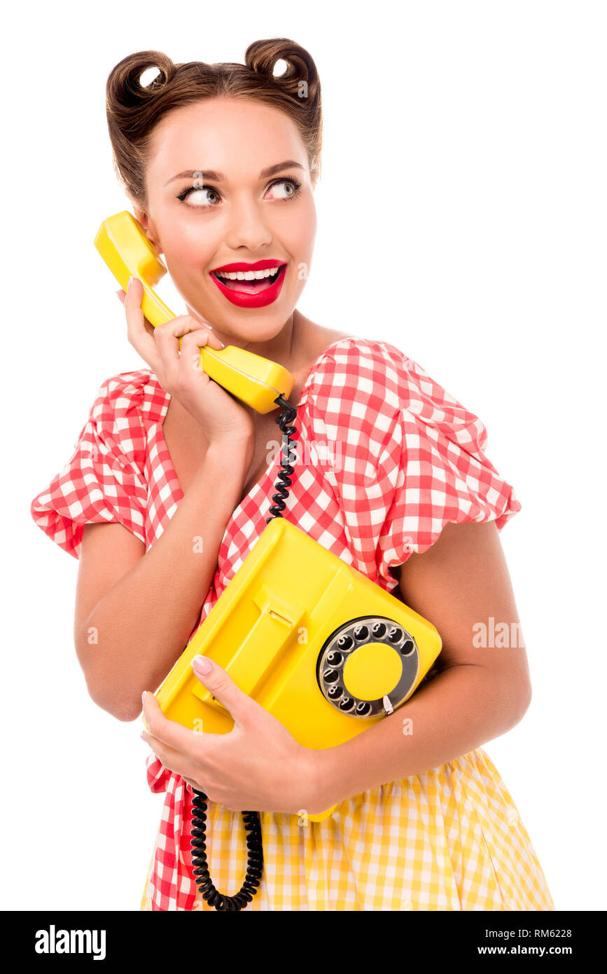 Smiling pin up girl talking on vintage yellow phone Stock Photo - Alamy