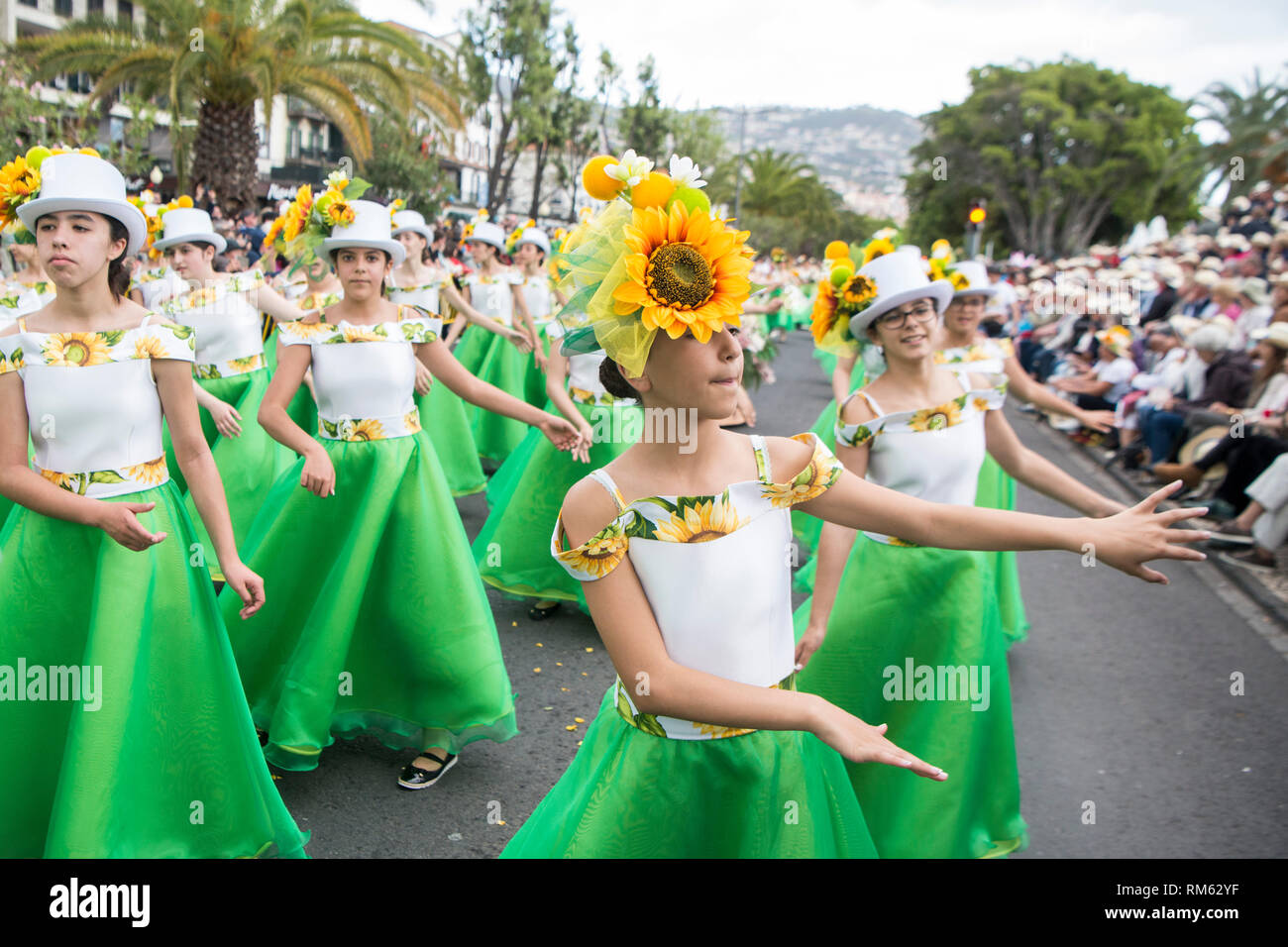 women dressed in colorful clothes at the Festa da Flor or Spring Flower ...