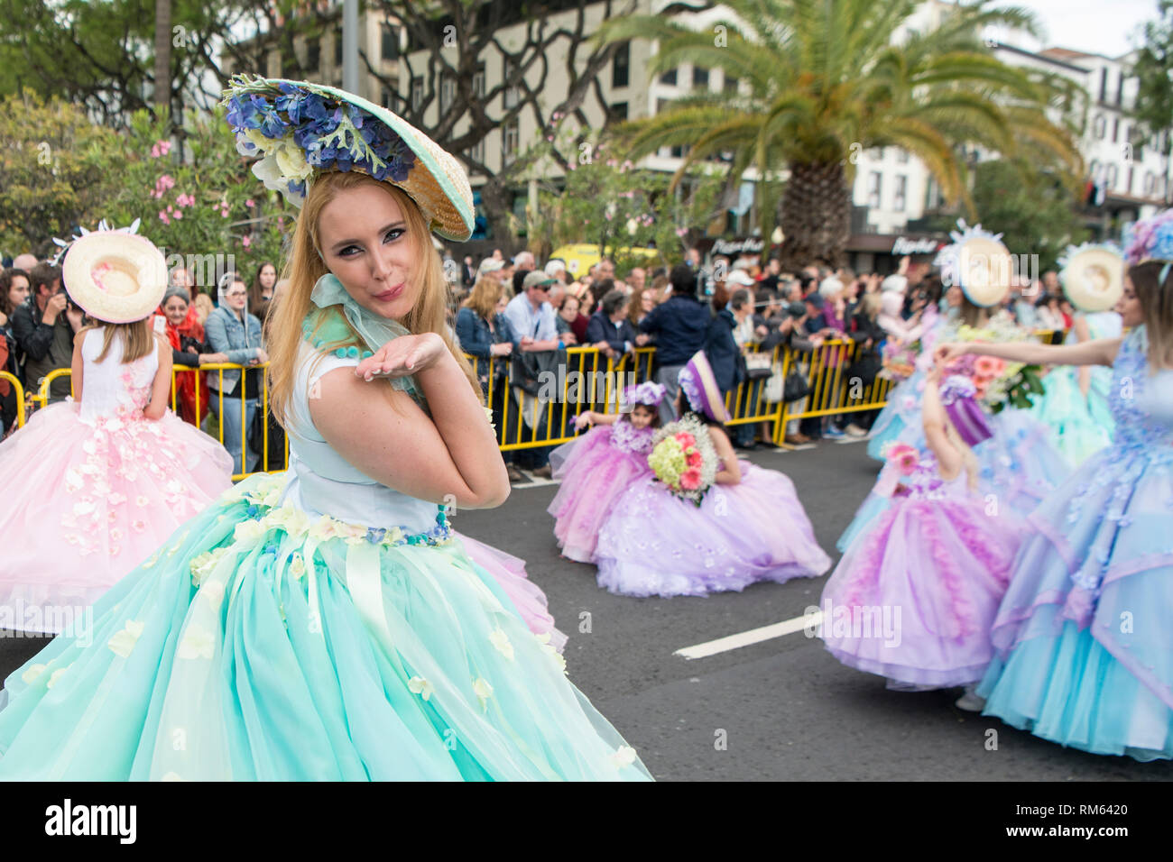 women dressed in colorful clothes at the Festa da Flor or Spring Flower ...