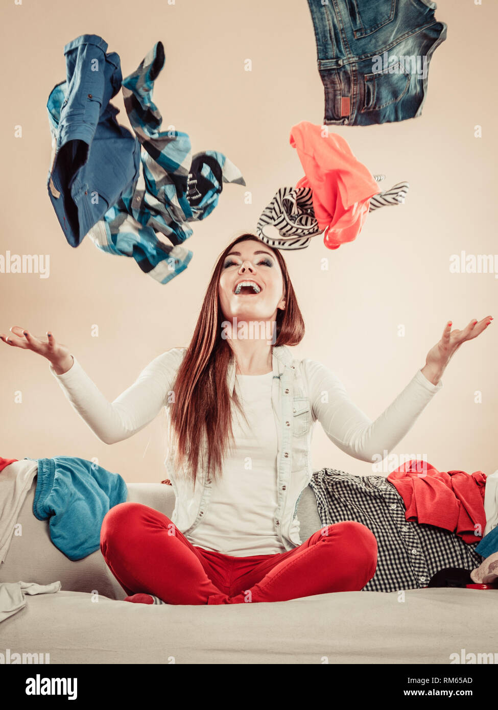 Lifestyle and clothing love for fashion. Young female sit on sofa full ...