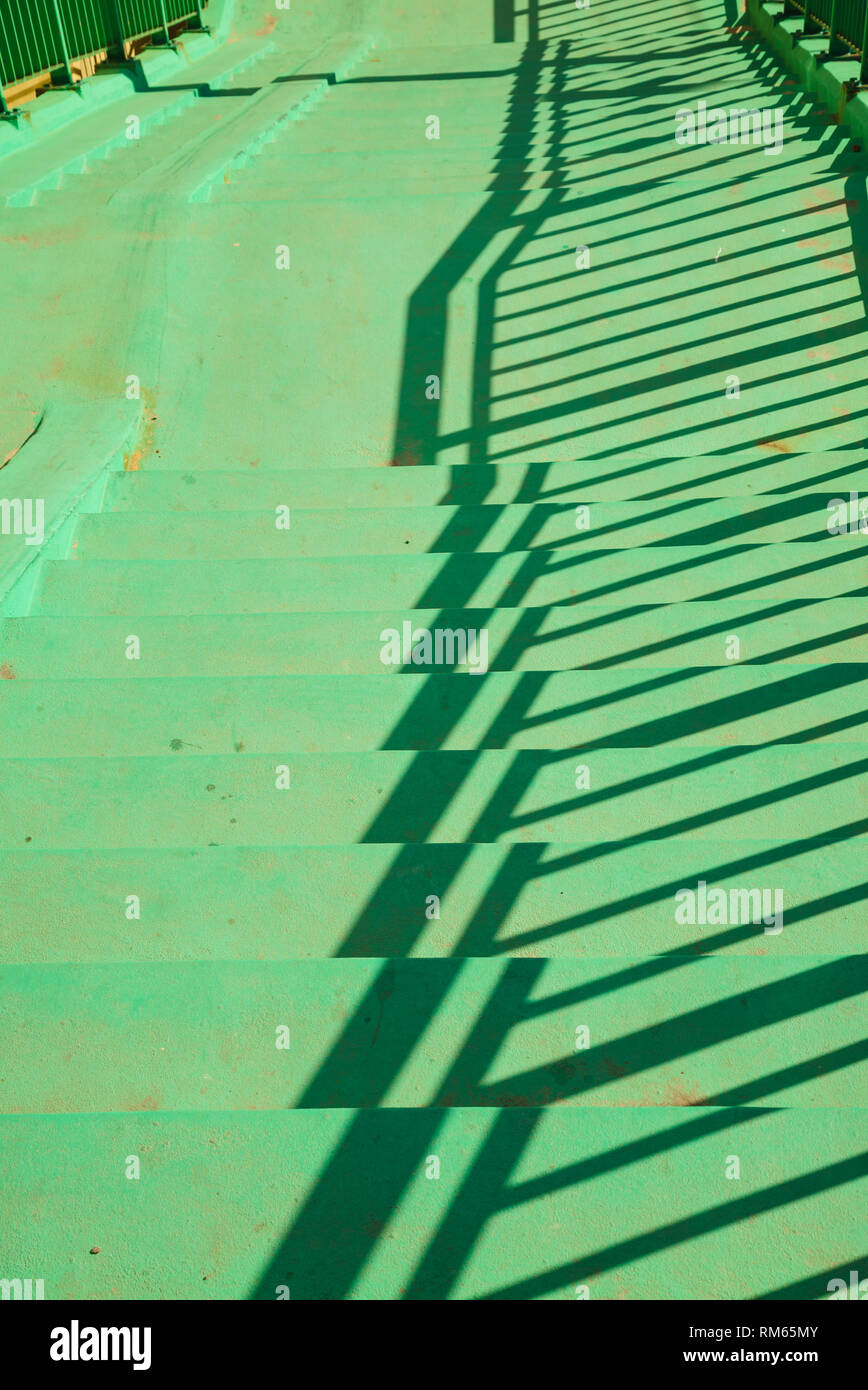 Green concrete stairs stairway with railing handrail on sunny day ...