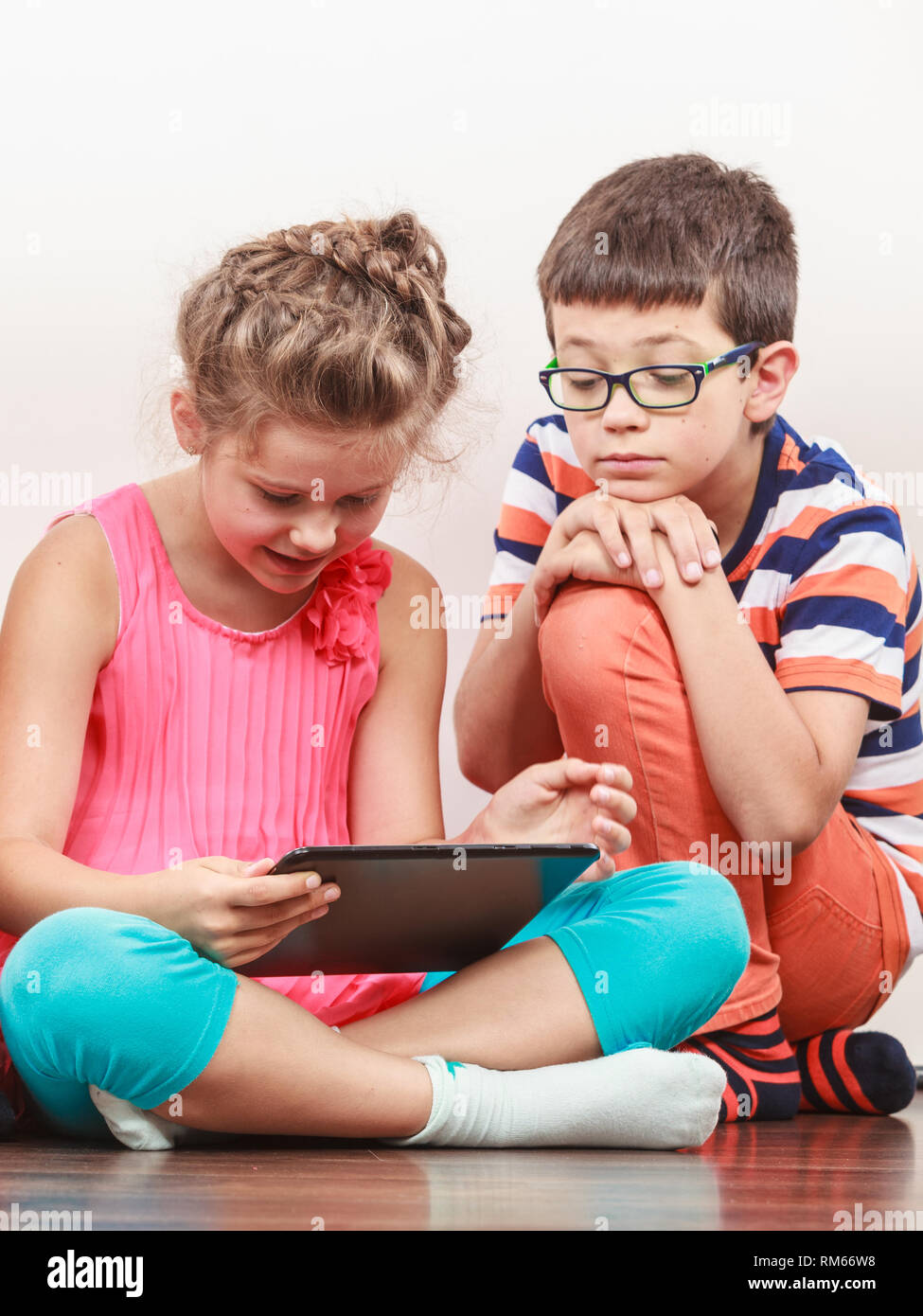 Kids playing on tablet. Having fun and learning Stock Photo - Alamy