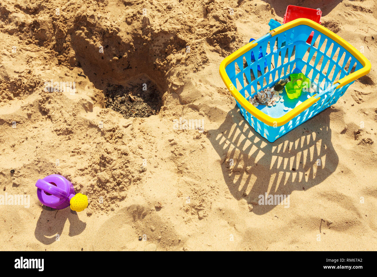 Summer fun time. Holidays and vacation. Childrens' toys lying on sand ...