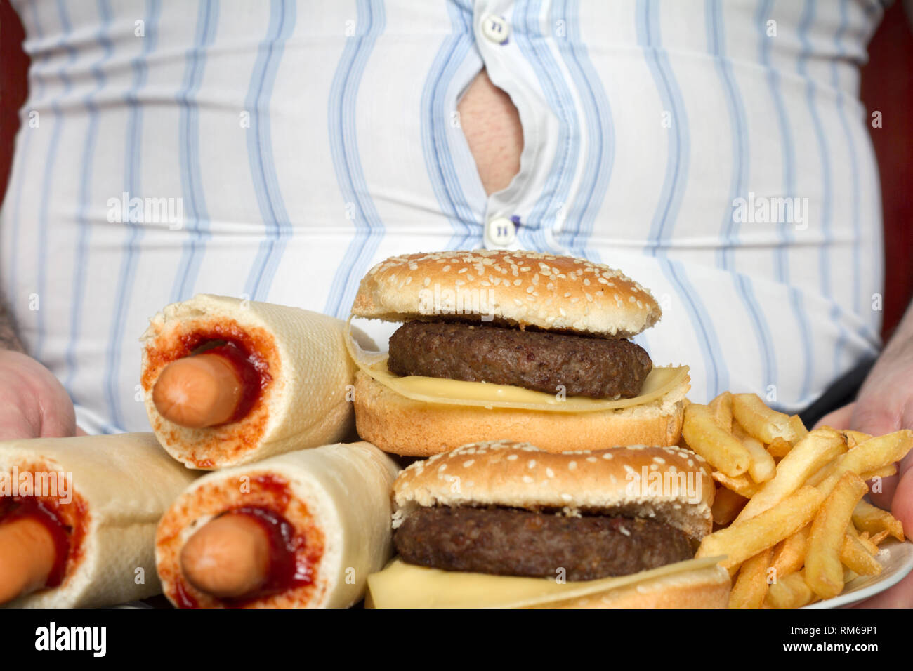Unhealthy junk fast food and belly of fat man Stock Photo - Alamy