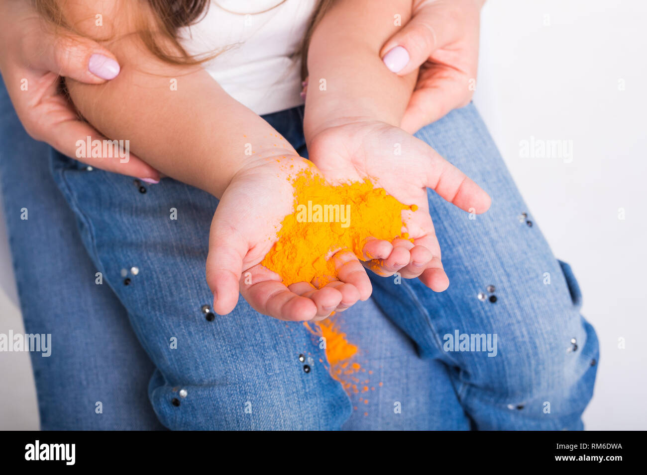 Festival of holi and holidays concept - baby's hand with colored powder ...