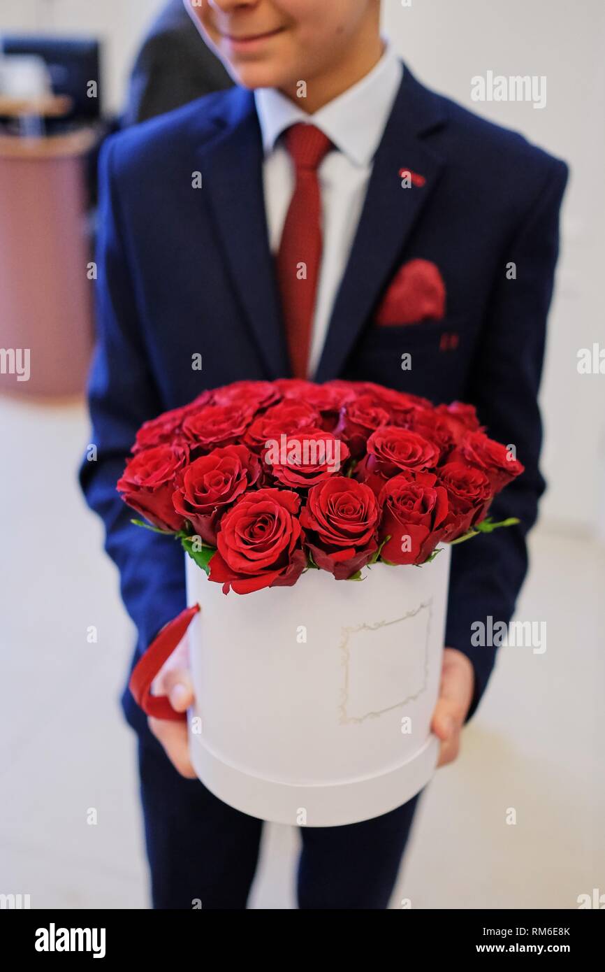 Men's hands hold a bucket of red roses in a bucket Stock Photo - Alamy