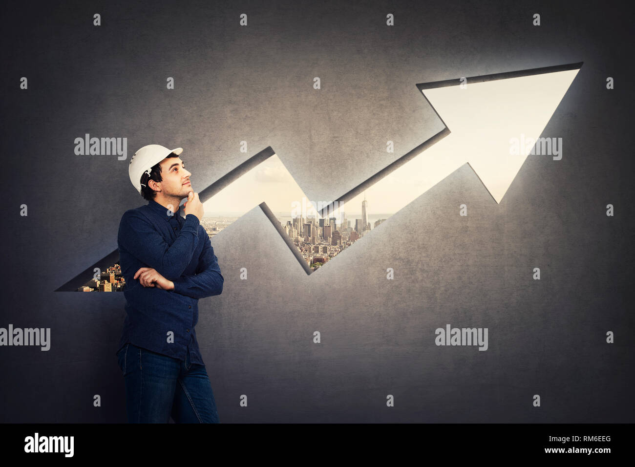 Wise engineer, wearing protective helmet, holding hand under chin ...