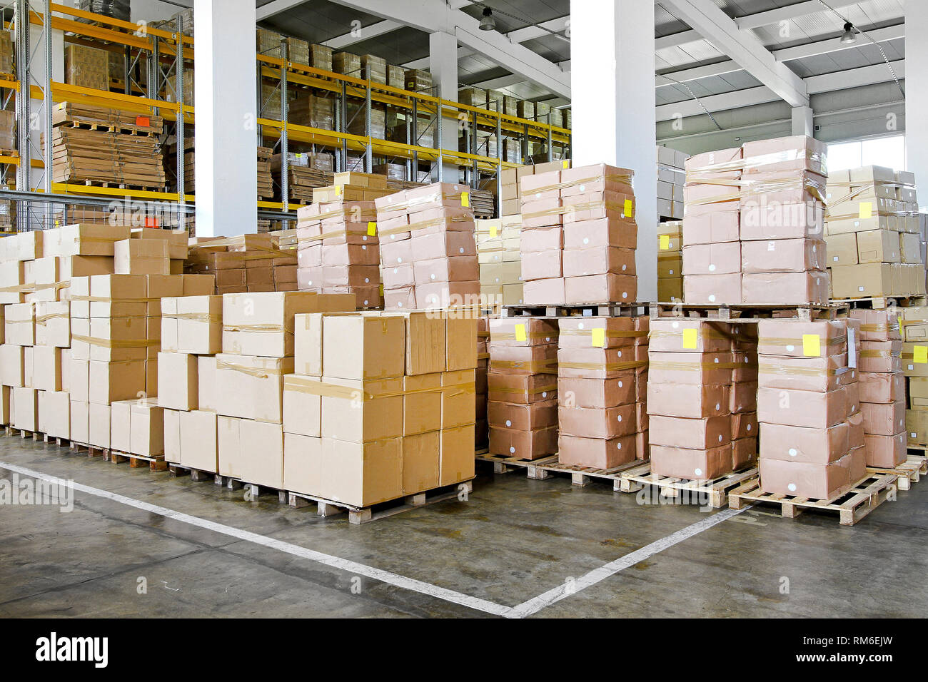 Big pile of boxes in distribution warehouse Stock Photo - Alamy