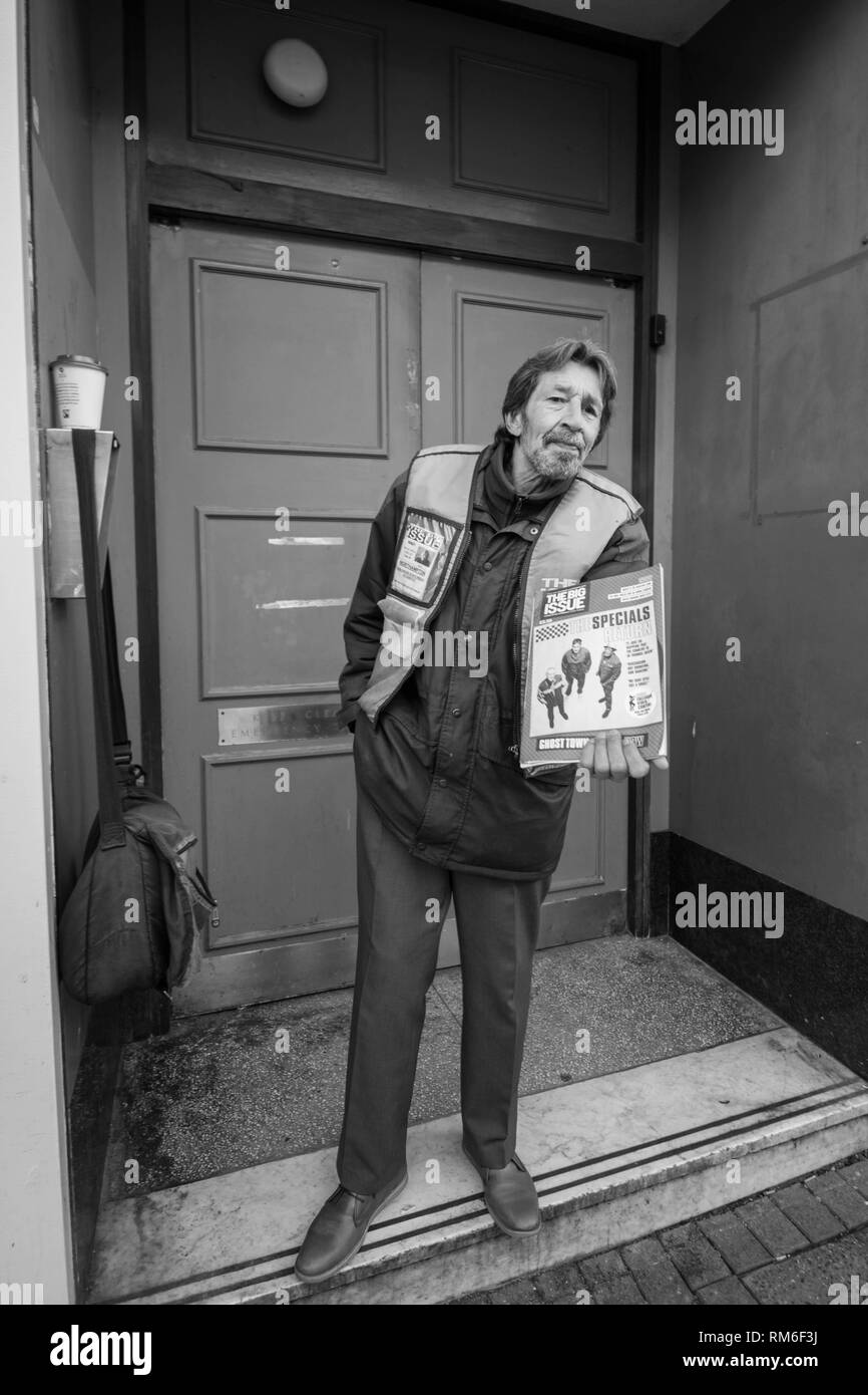 Homeless man selling papers in Northampton UK Stock Photo - Alamy