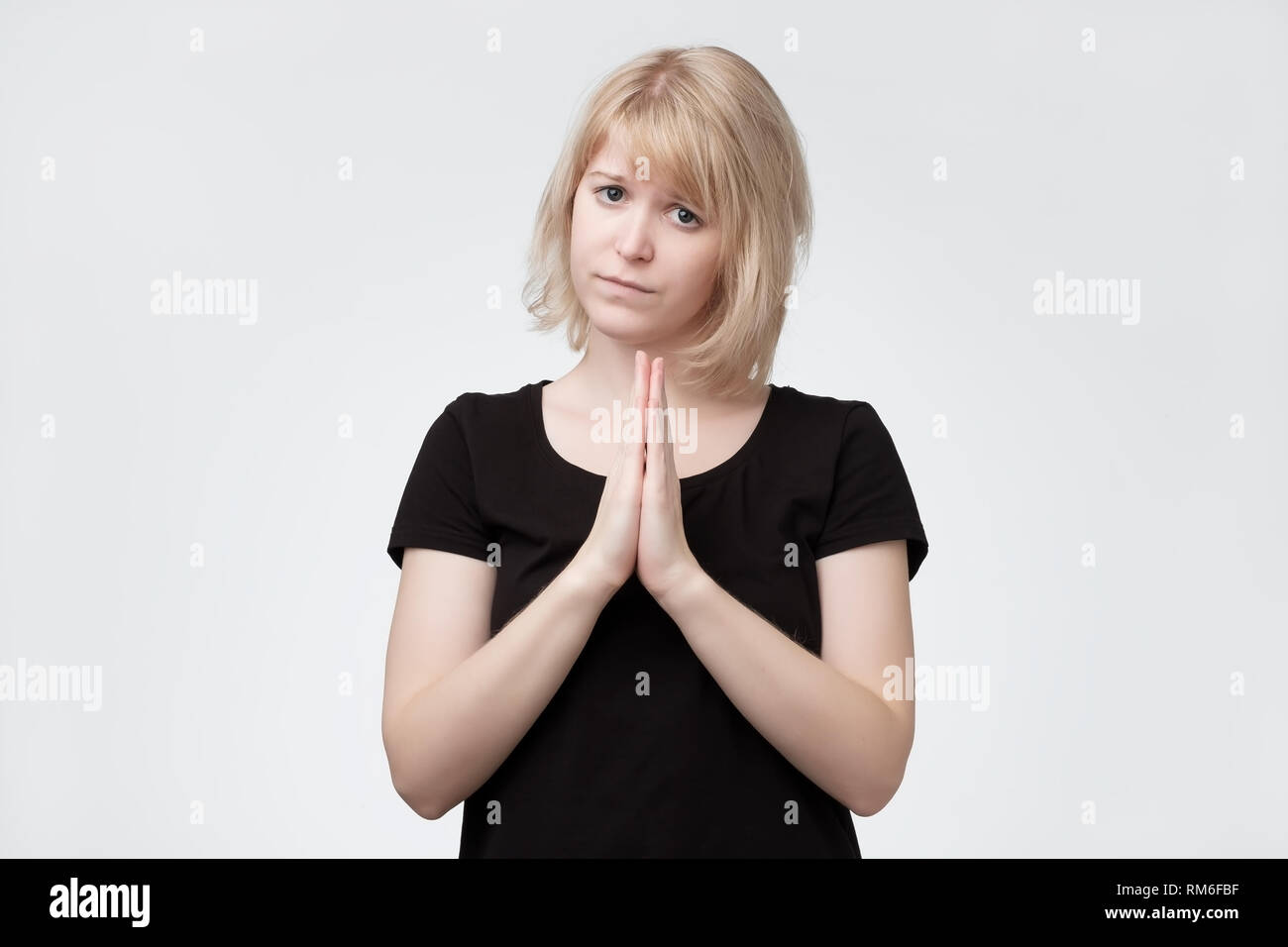 Begging young woman portrait hi-res stock photography and images - Alamy