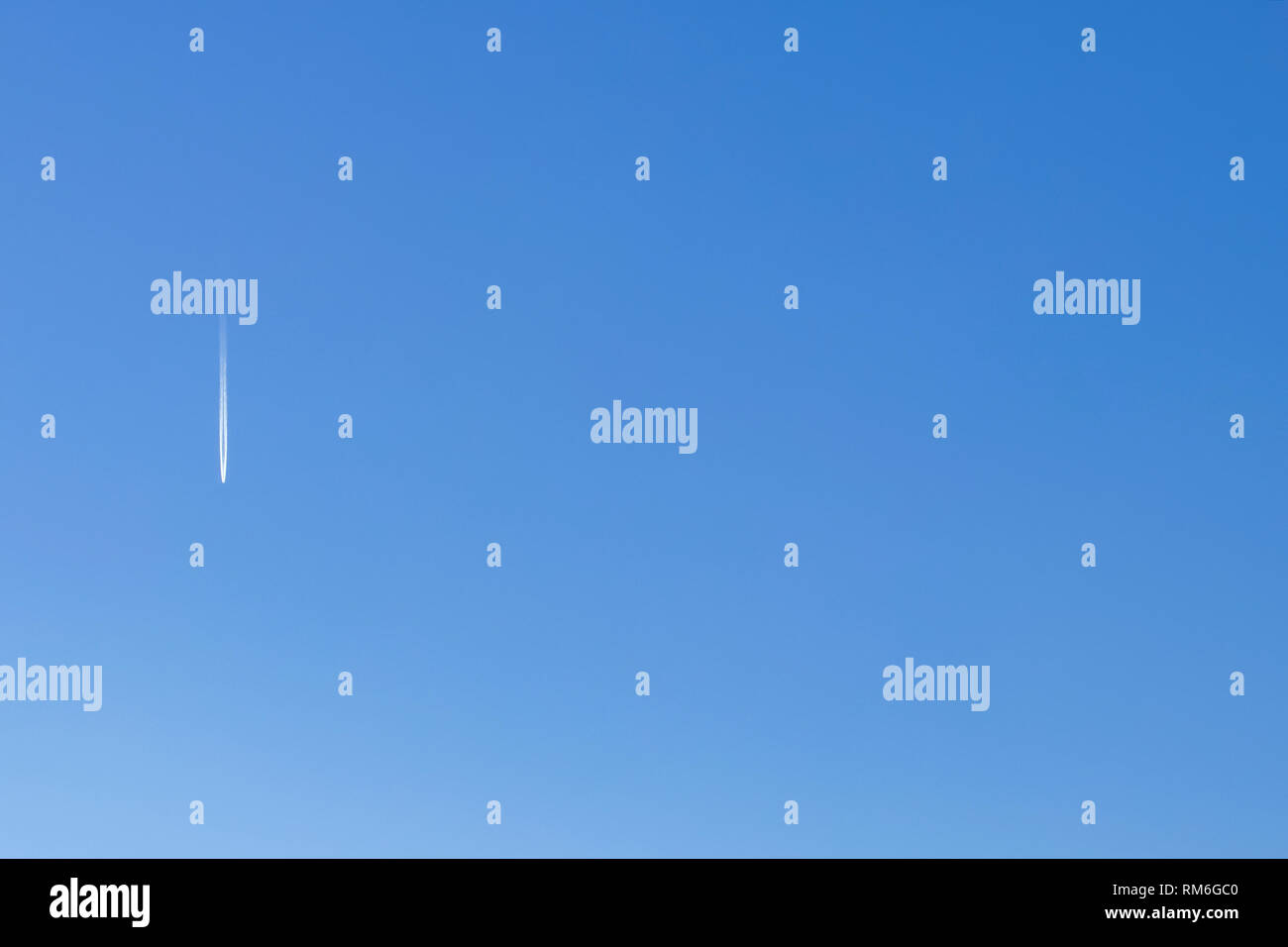 Blue clear sky with a plane in the distance. Natural background for ...