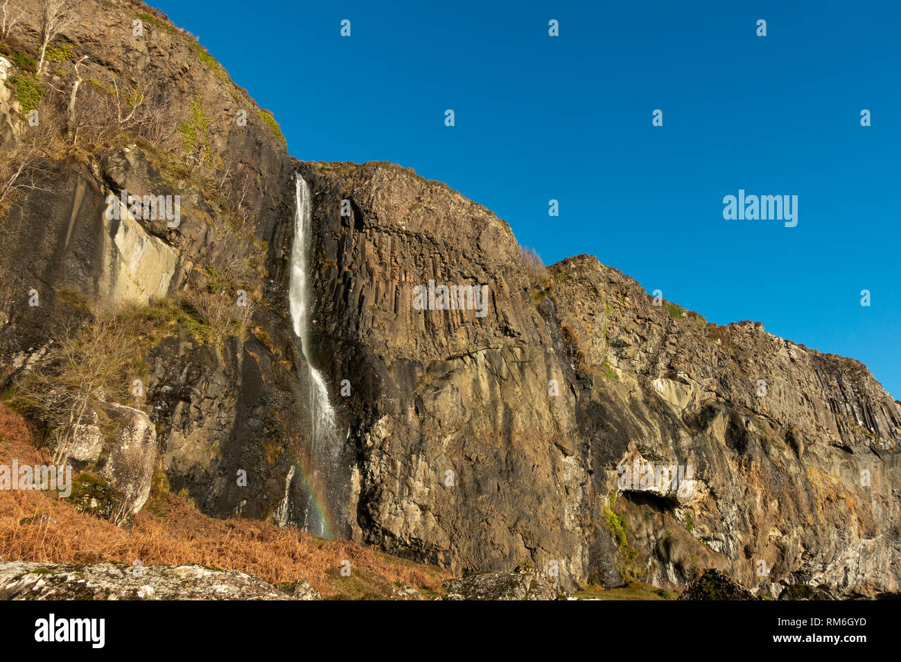 Rainbow at the bottom of Rubha Dubh waterfall on the Carsaig cliffs of ...