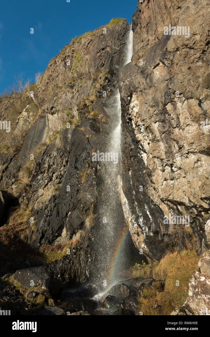 Rainbow at the bottom of Rubha Dubh waterfall on the Carsaig cliffs ...