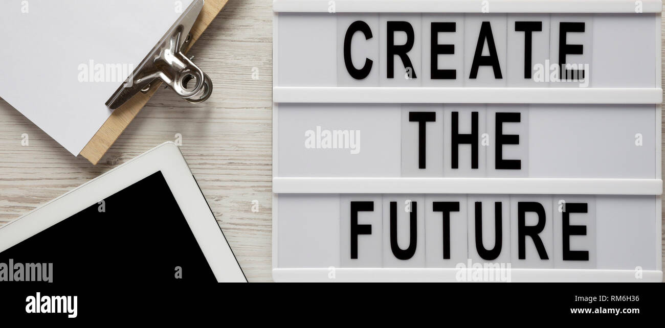 Modern board with text 'Create the future', clipboard with sheet of ...