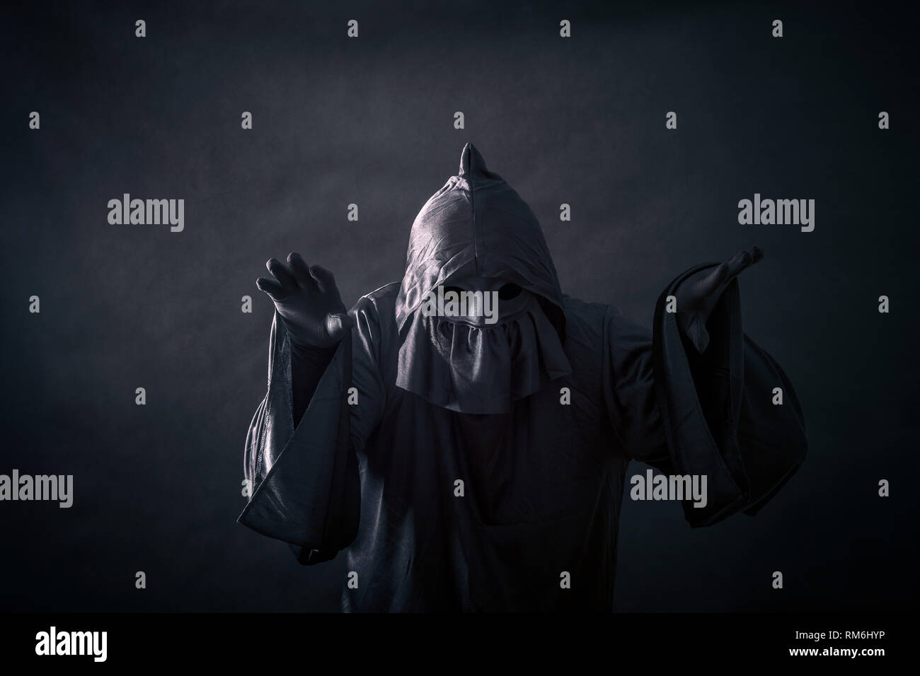 Scary figure in hooded cloak Stock Photo - Alamy