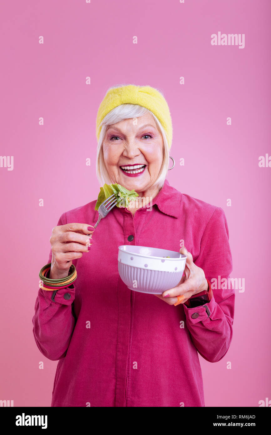 Beautiful elderly lady feeling good while eating vegetable salad Stock ...