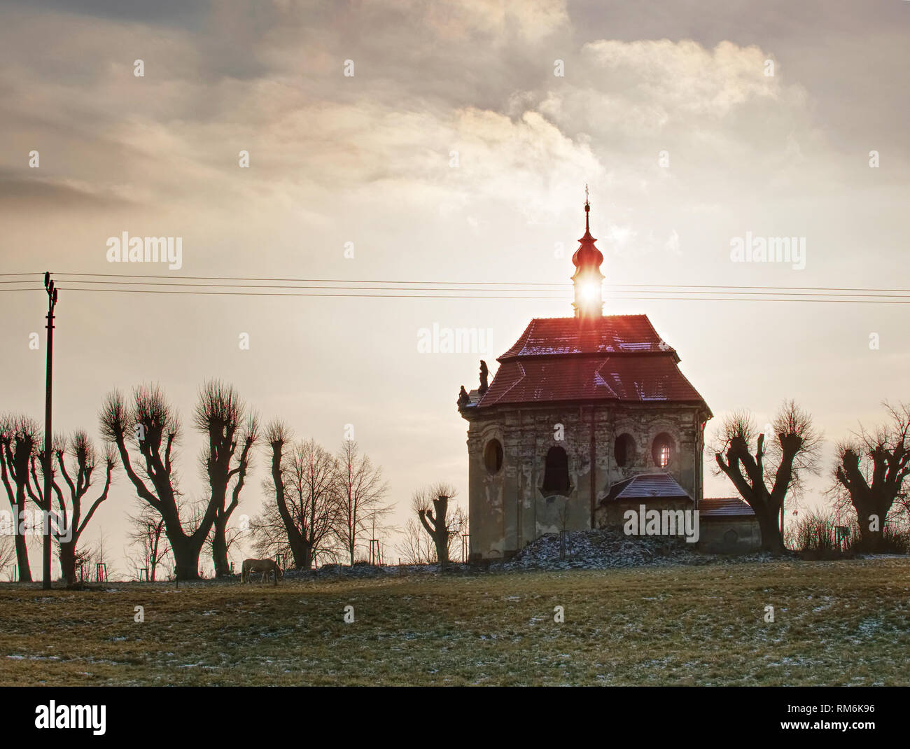Farm meadow for horses at village church or chapel. End of civilization ...