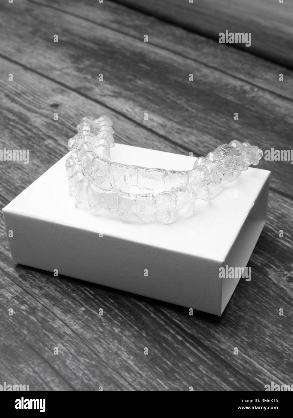 Invisalign braces. Invisible brackets on white box Stock Photo - Alamy