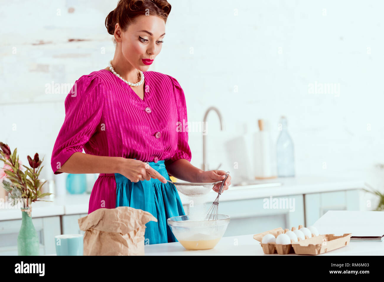 Beautiful pin up girl mixing ingredients for dough Stock Photo - Alamy