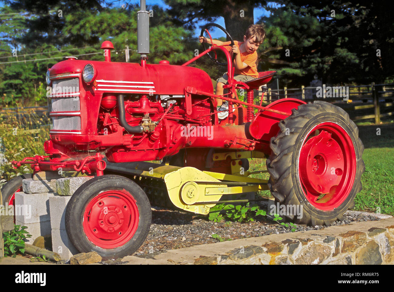 toddler boy playing, stationary red tractor, pretend driving, fun ...