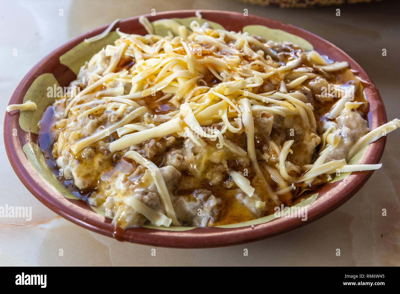 Plate of Yemeni banana and honey bread pudding masoob Stock Photo - Alamy