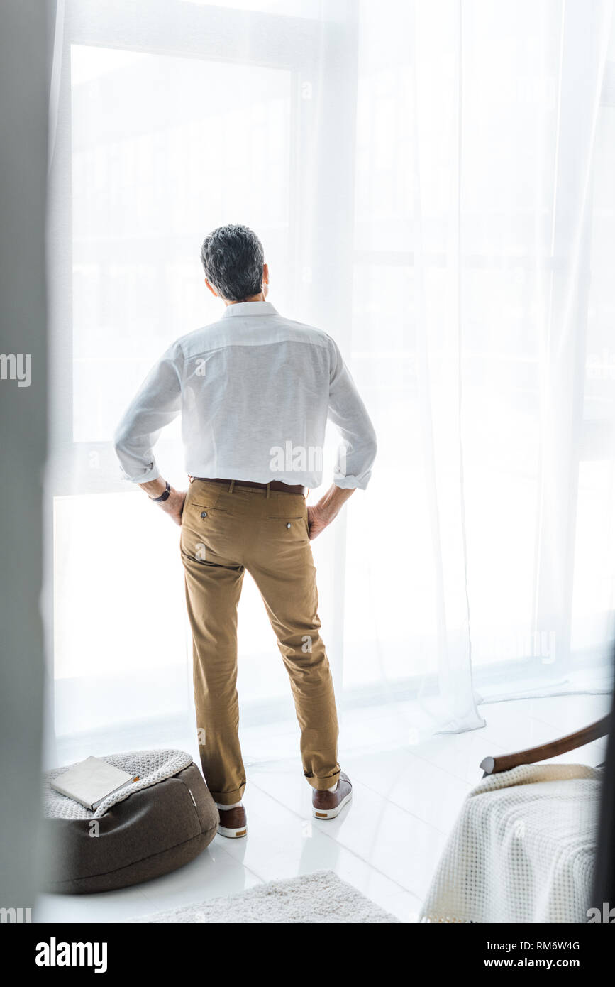 back view of senior man standing at modern home Stock Photo - Alamy