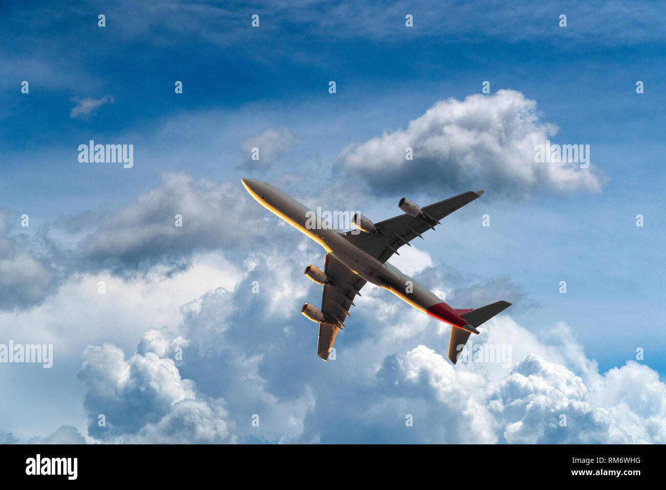 airplane taking off on cloudy sky sunset background Stock Photo - Alamy