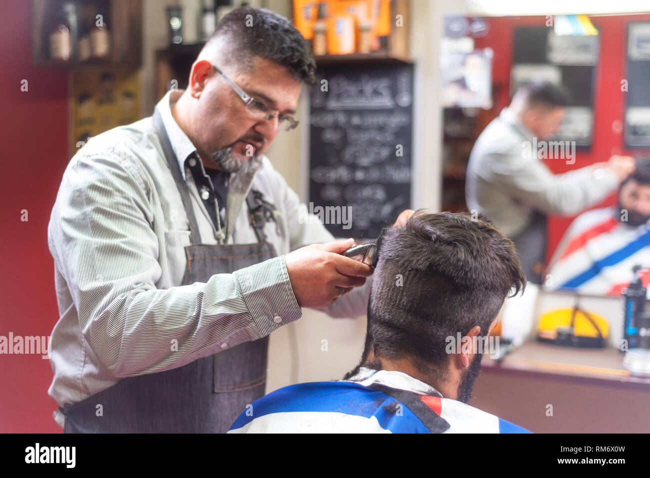 Barber shop customer getting haircut hair cut hi-res stock photography ...