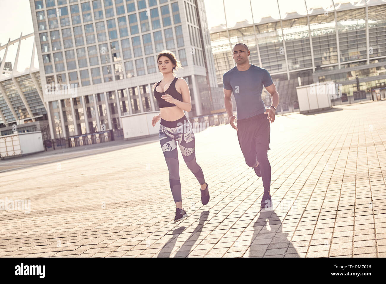 Living healthy. Full length portrait of cute sporty couple running ...