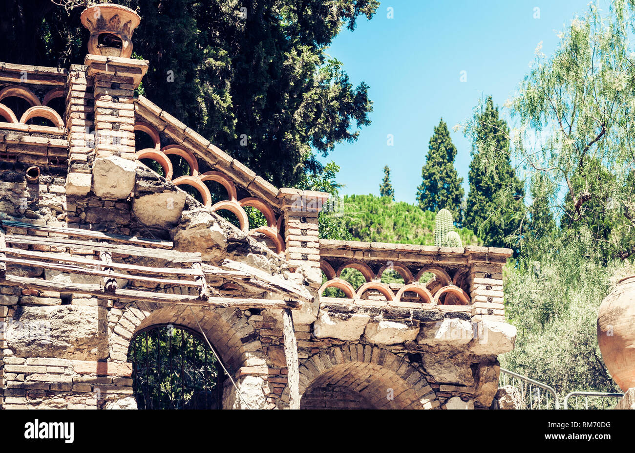 A pavilion or gazebo with clay fence in a beautiful public garden park ...