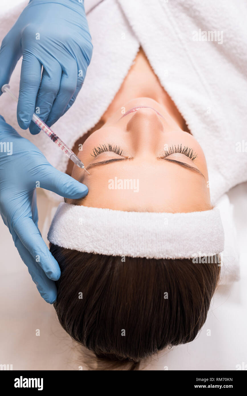 beautician injecting woman face at beauty salon Stock Photo - Alamy