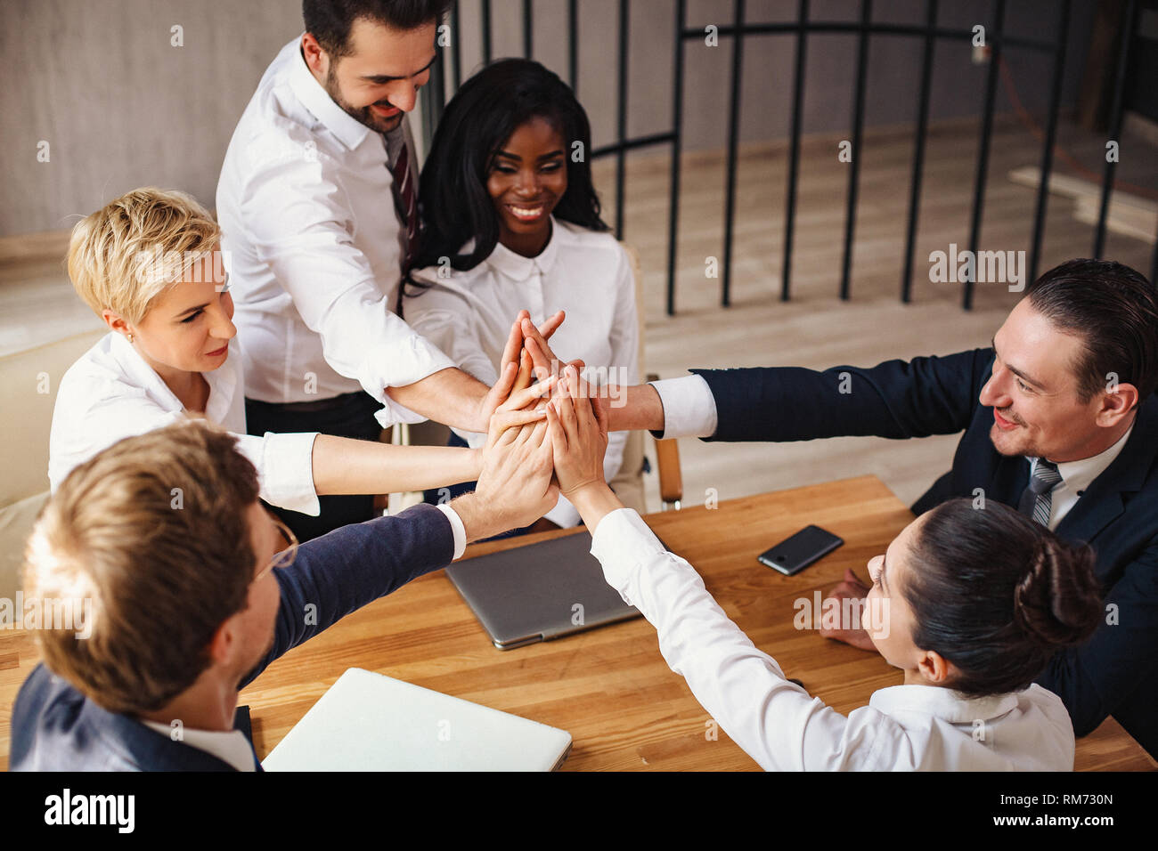Business people join hands celebrating success Stock Photo - Alamy