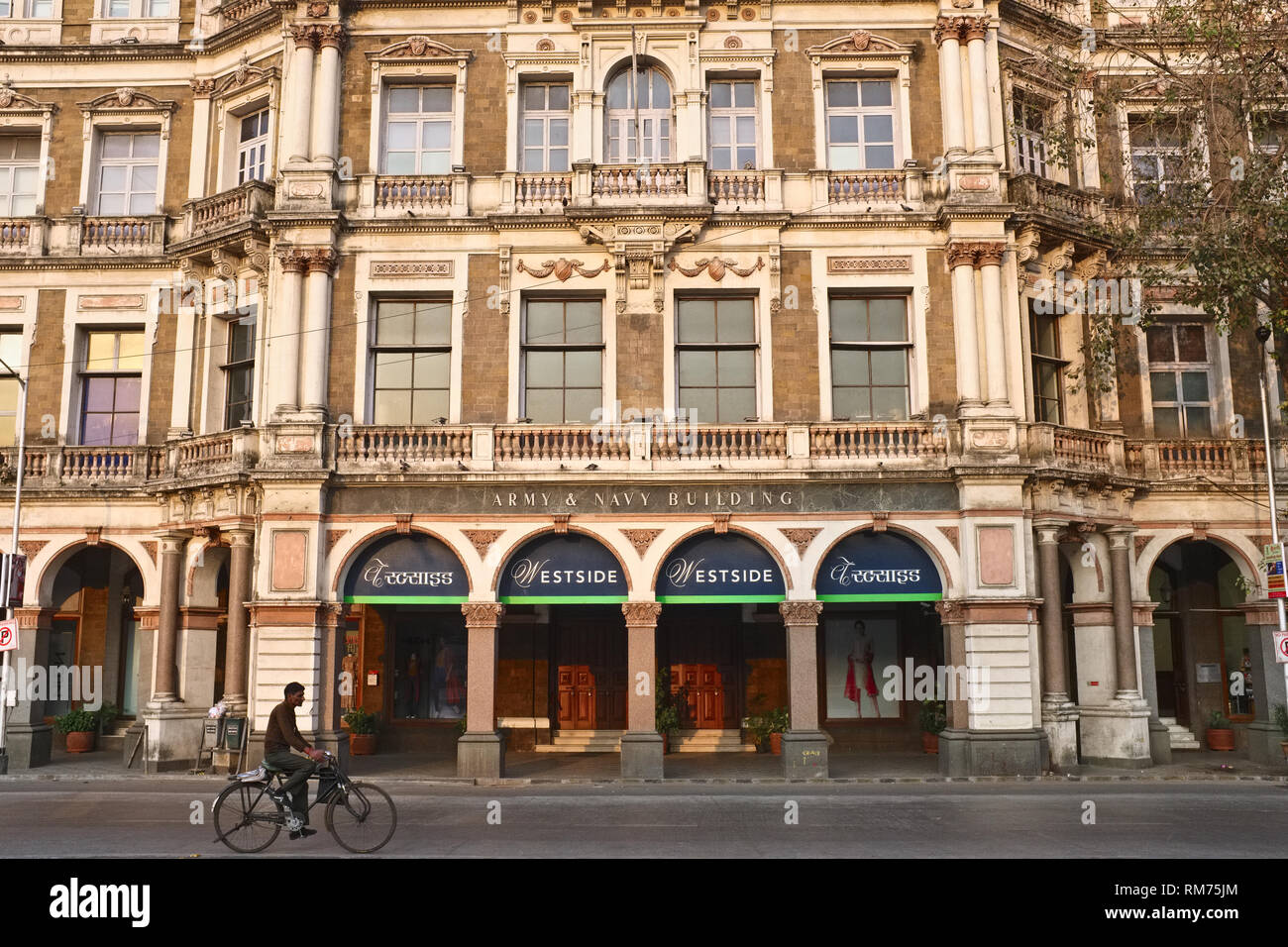 A cyclist passing Army & Navy Building in Kala Ghoda area, Fort, Mumbai ...