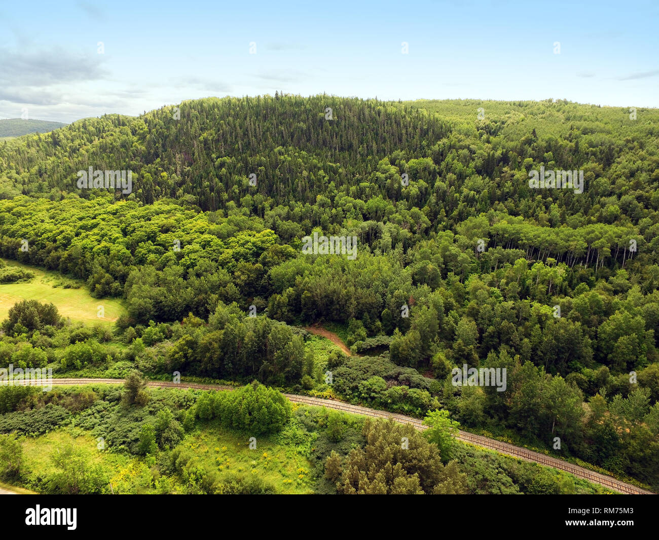 Aerial view of a forested hill with railway Stock Photo - Alamy