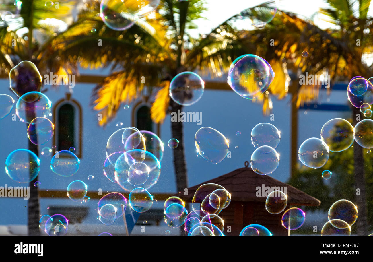 Background with many soap bubbles in air on city street, outdoor fun ...