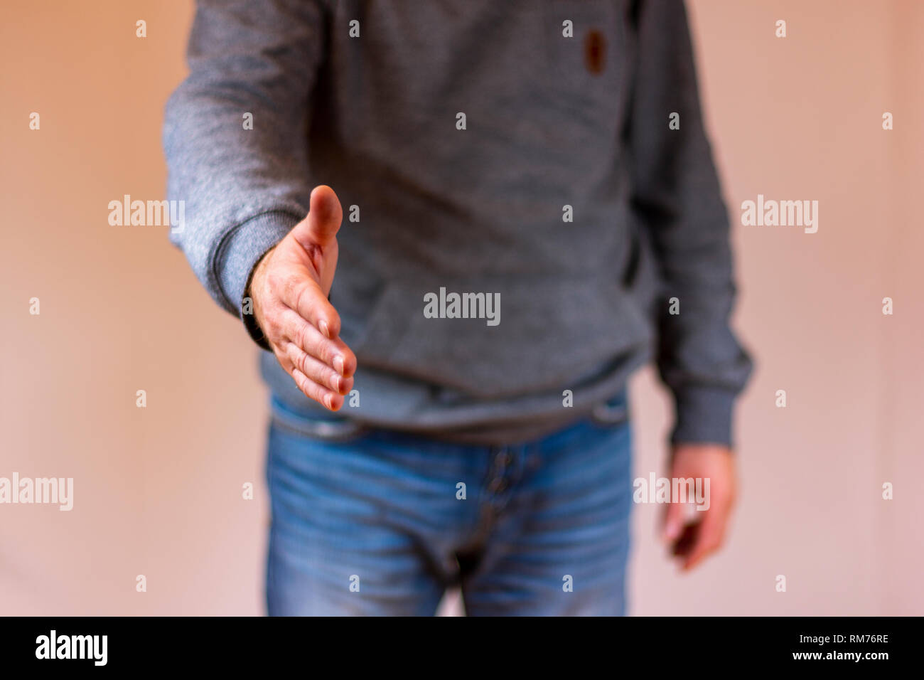 Hand reaching out for a handshake Stock Photo - Alamy