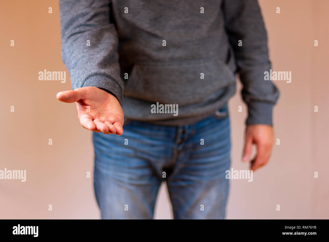 Hand reaching out for a handshake Stock Photo - Alamy