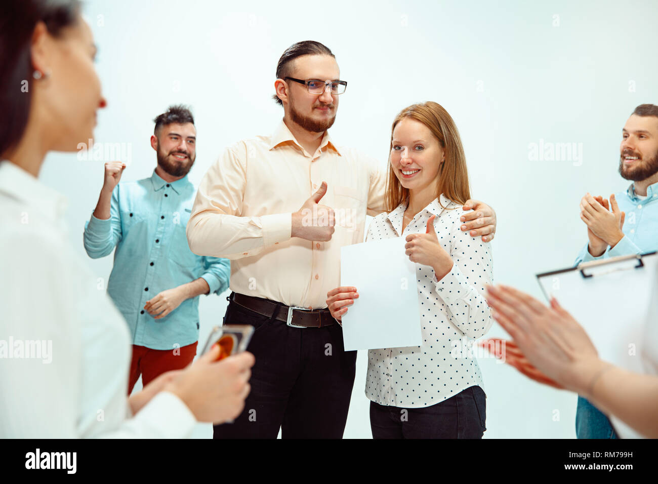 Boss approving and congratulating young successful employee of the ...