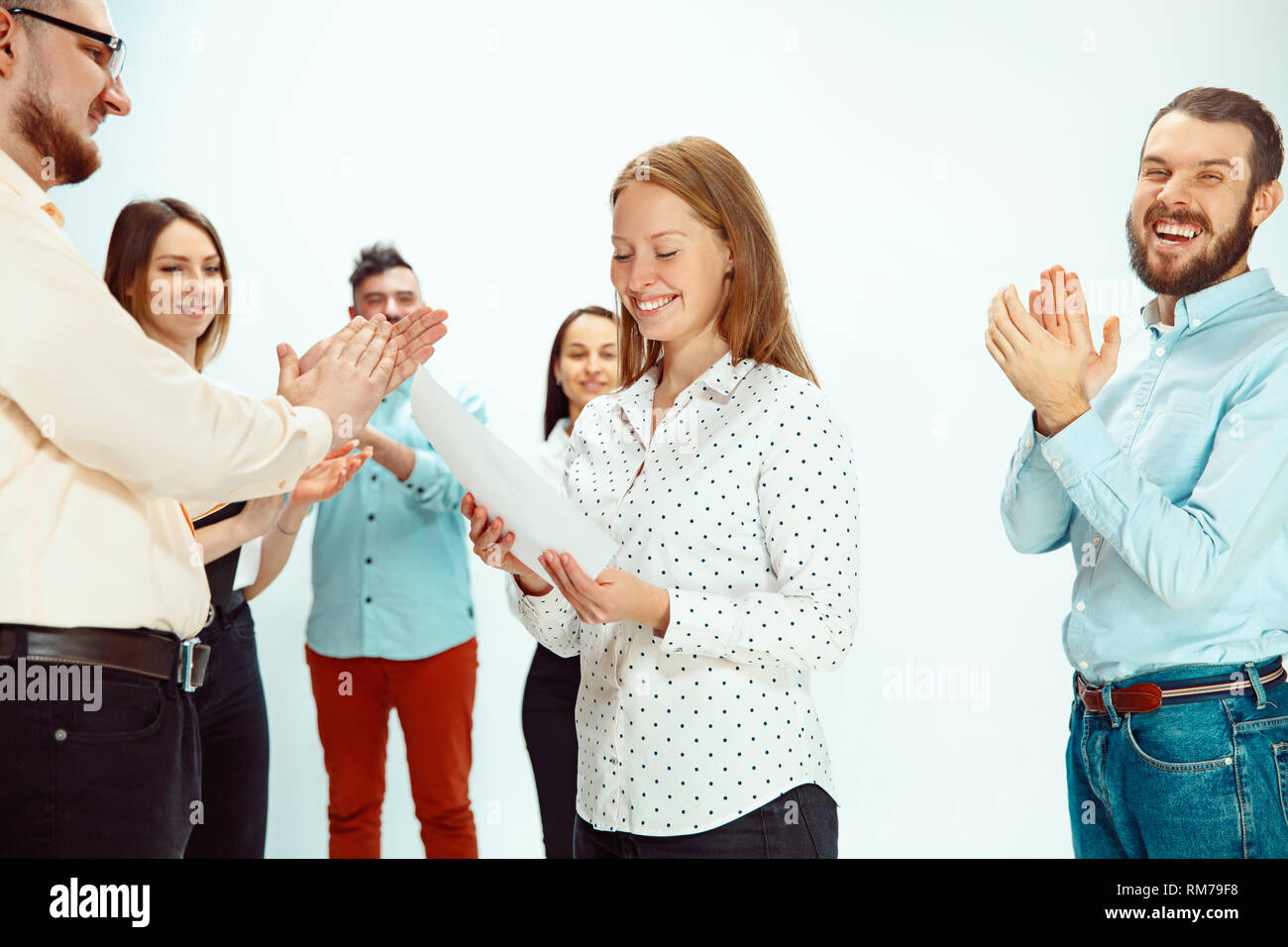 Boss approving and congratulating young successful employee of the ...