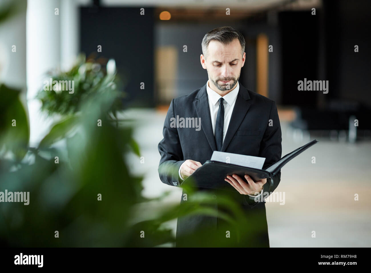 Looking through documents Stock Photo - Alamy