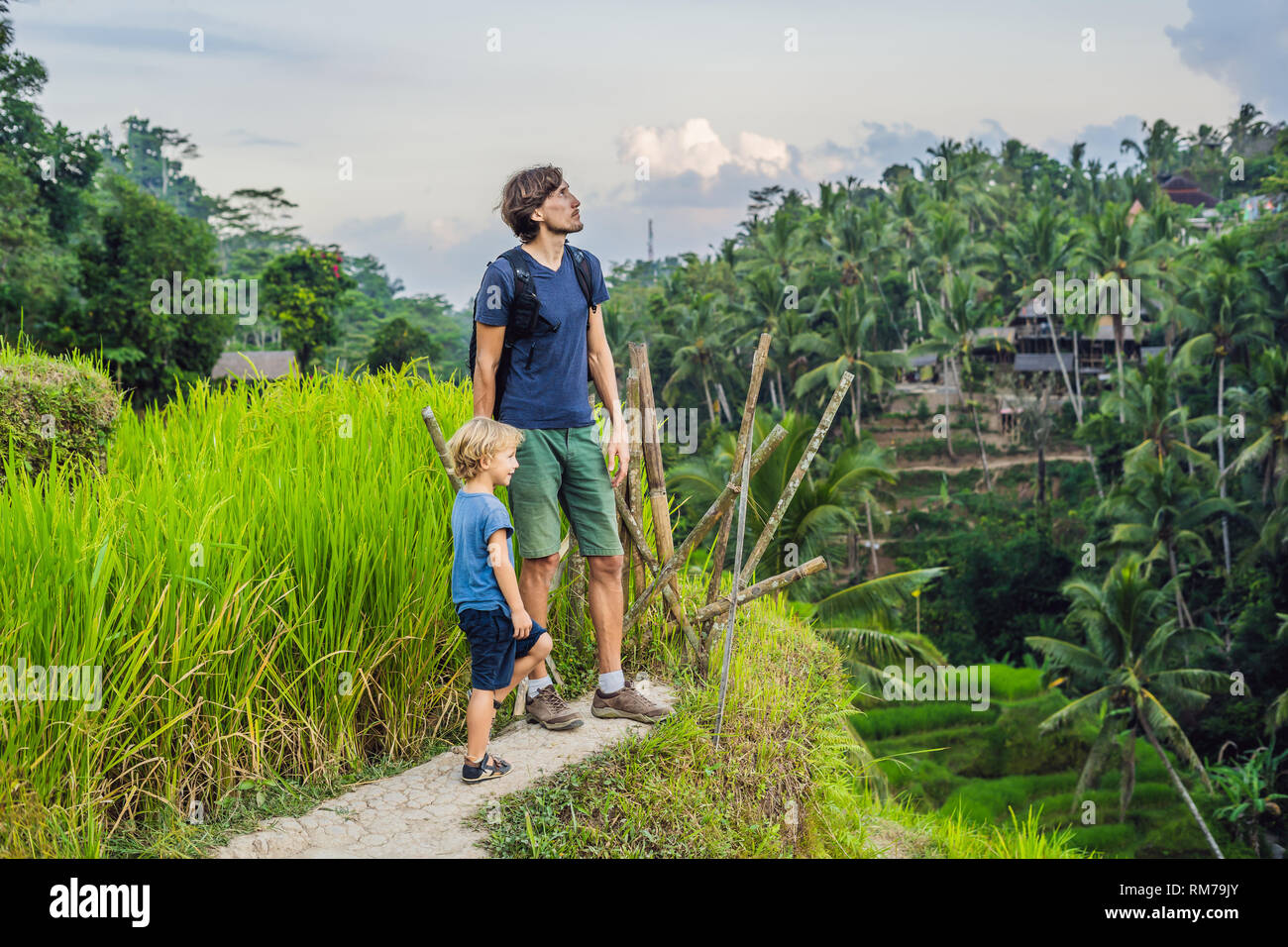Dad and son on the rice field in the background of rice terraces, Ubud ...