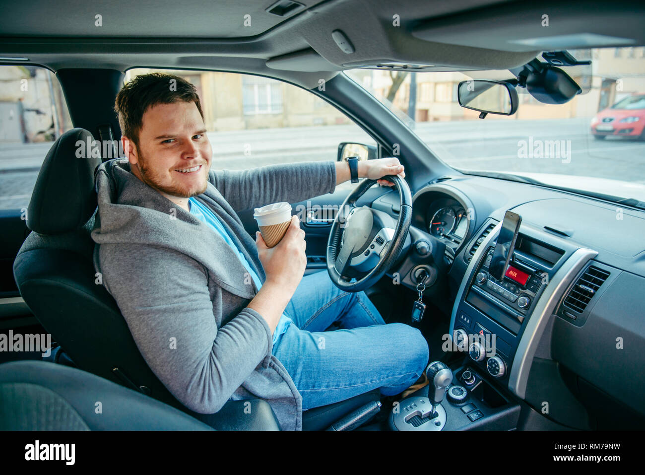 smiling man driving car and drinking coffee. lifestyle. road trip Stock ...