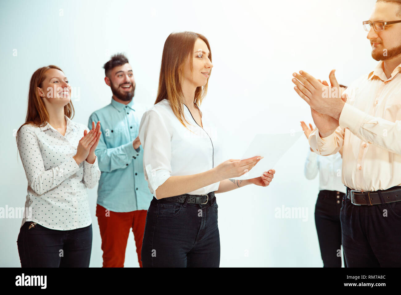 Boss approving and congratulating young successful employee of the ...