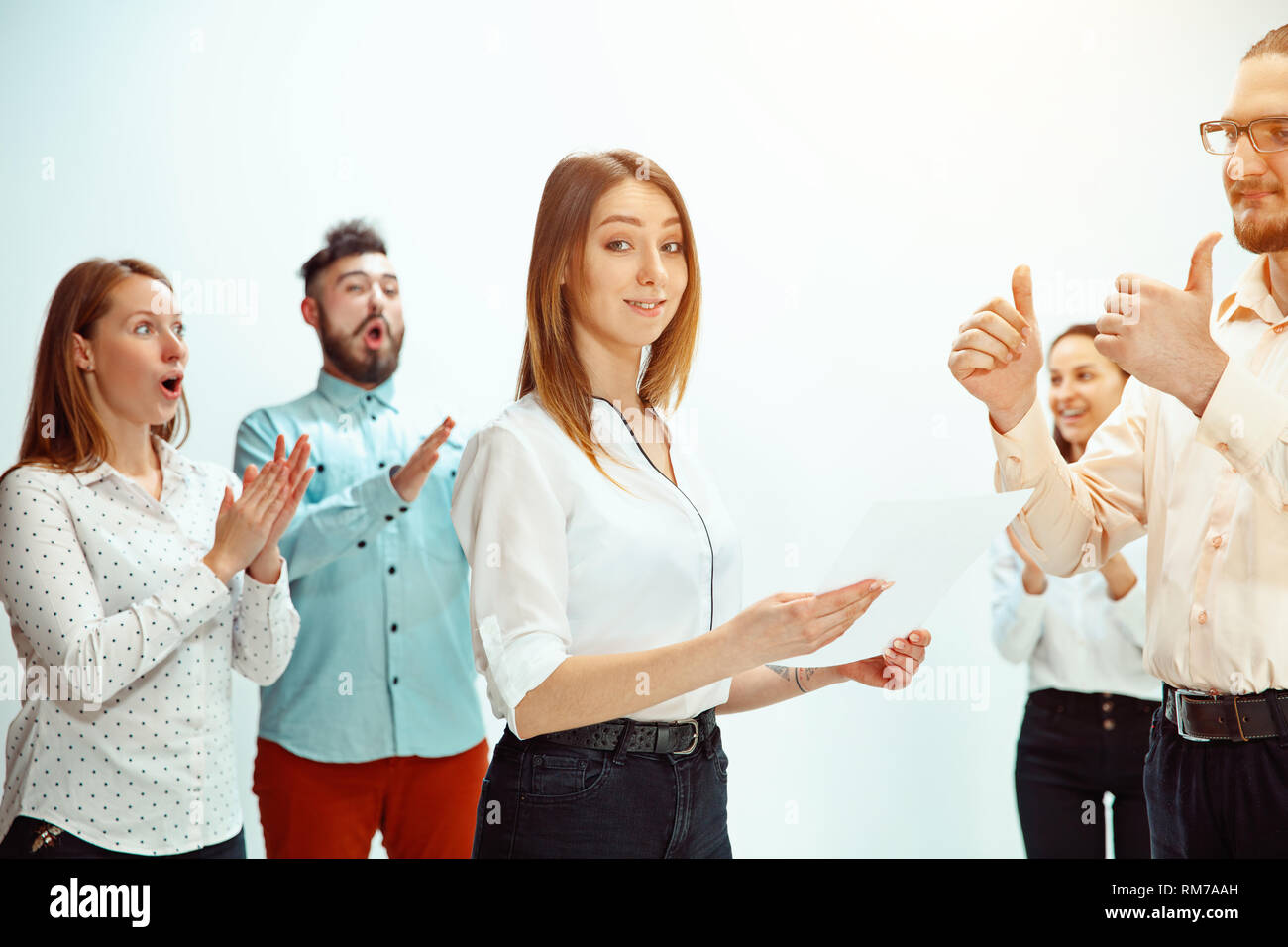 Boss approving and congratulating young successful employee of the ...