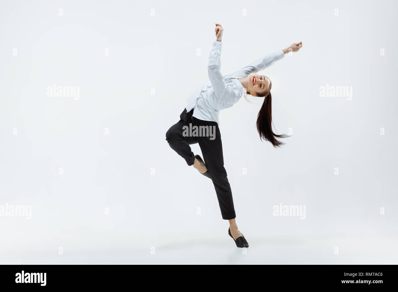 Happy businesswoman dancing and smiling in motion isolated on white ...
