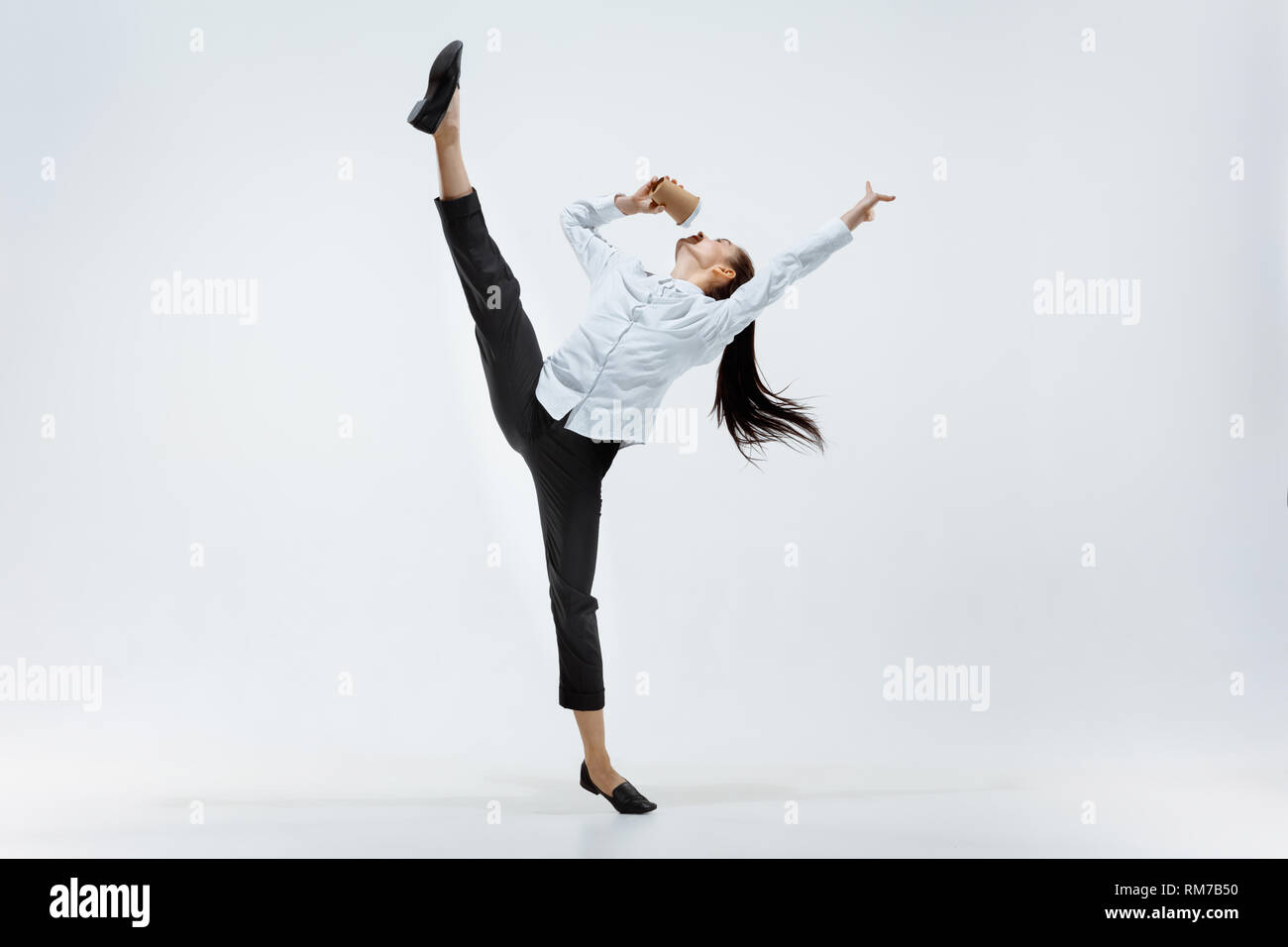 Happy businesswoman dancing and smiling in motion isolated on white ...