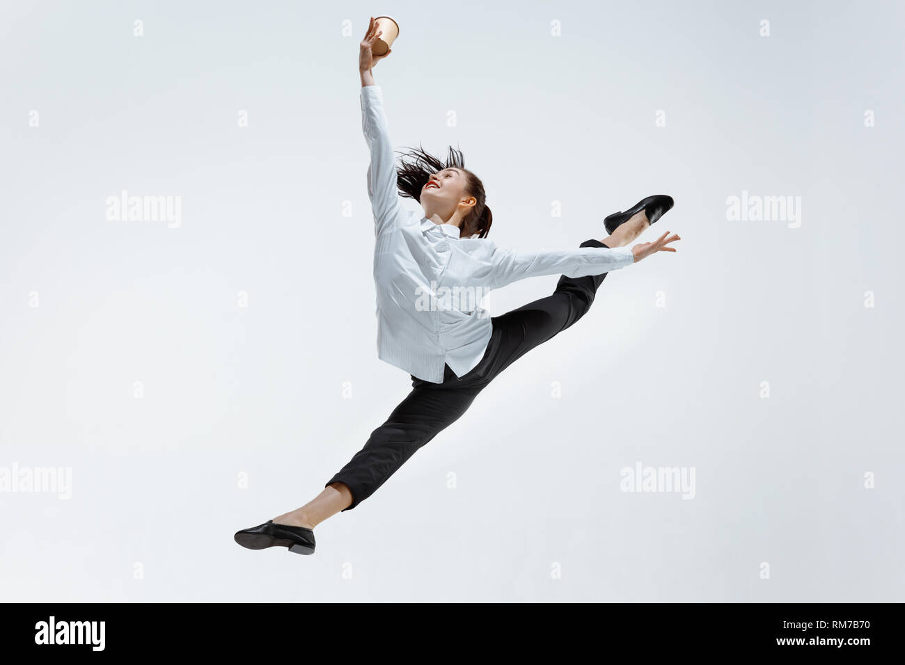 Happy businesswoman dancing and smiling in motion isolated on white ...