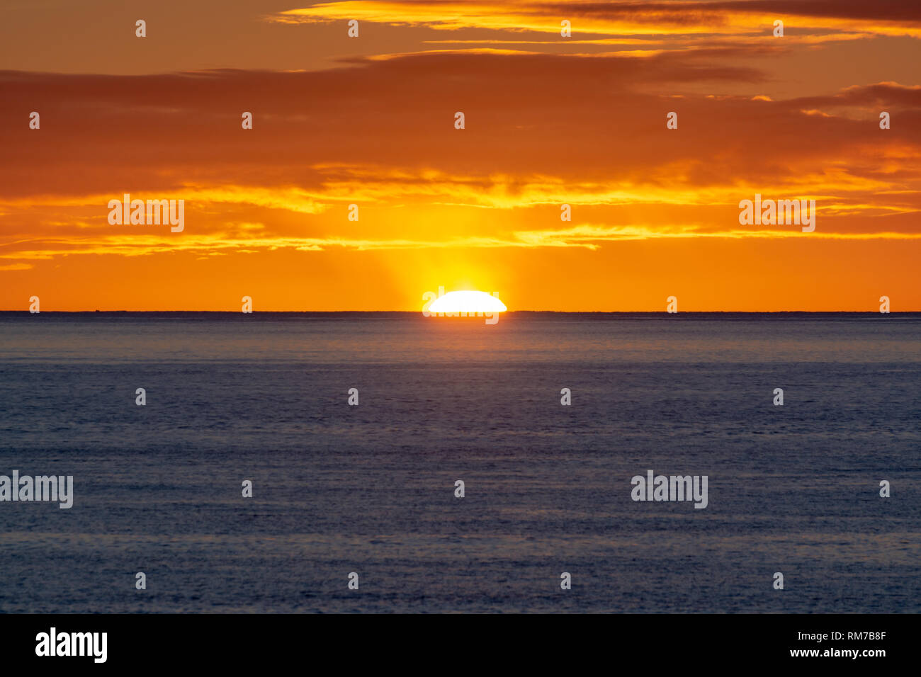 Landscape with colorful sunrise over dark blue ocean water Stock Photo ...